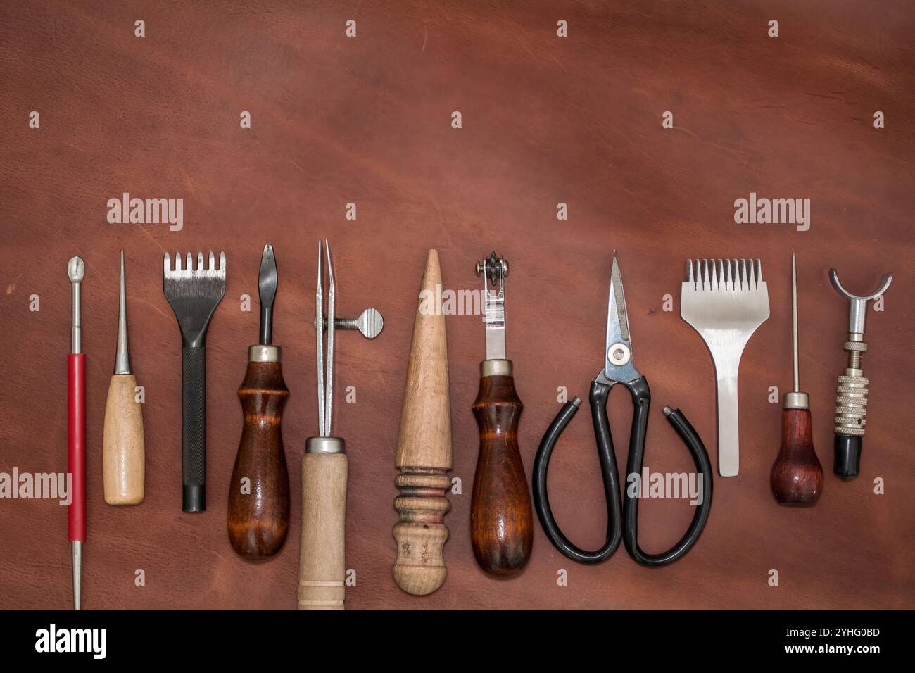 Pieces of natural calf leather and tools for leather processing. A ...