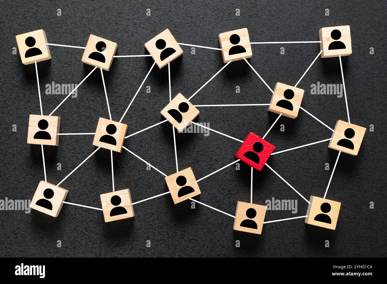 Wooden blocks connected together on a black background Stock Photo - Alamy