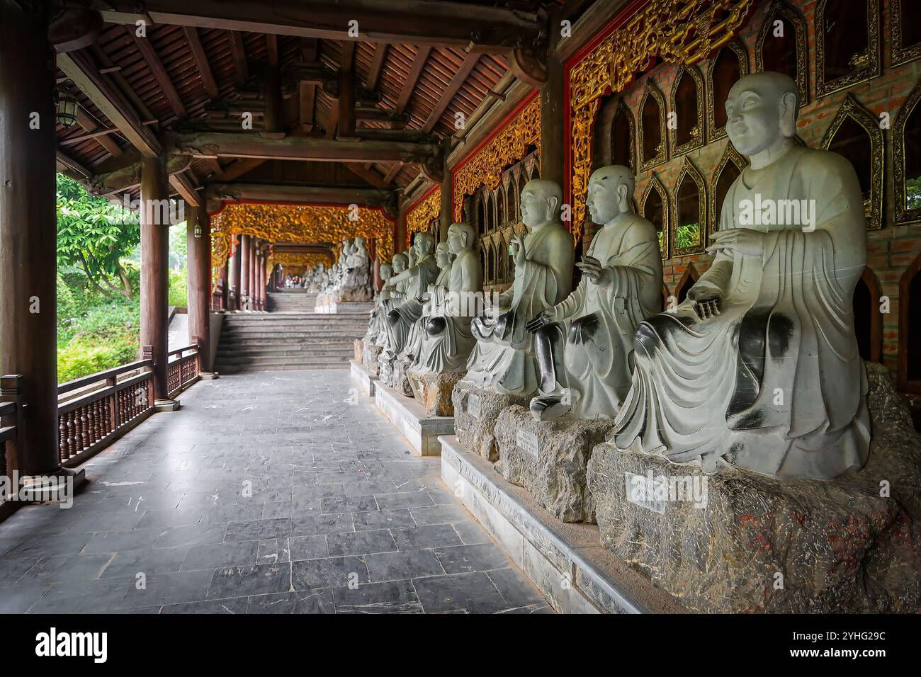 Statues of Arhats lining a traditional corridor in the Bai Dinh Pagoda ...