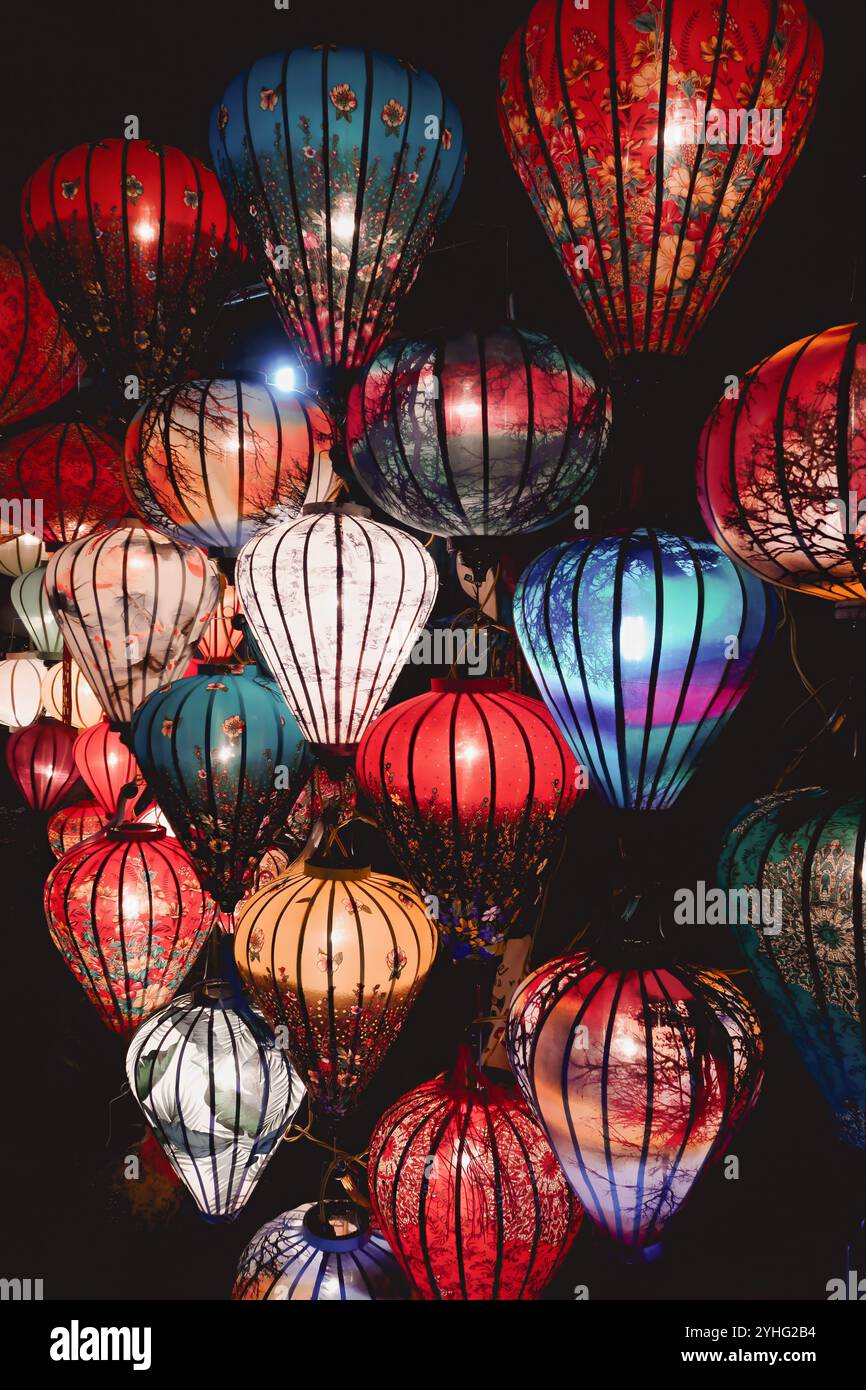 A colorful display of traditional Vietnamese lanterns in Hoi An, showcasing intricate patterns ...