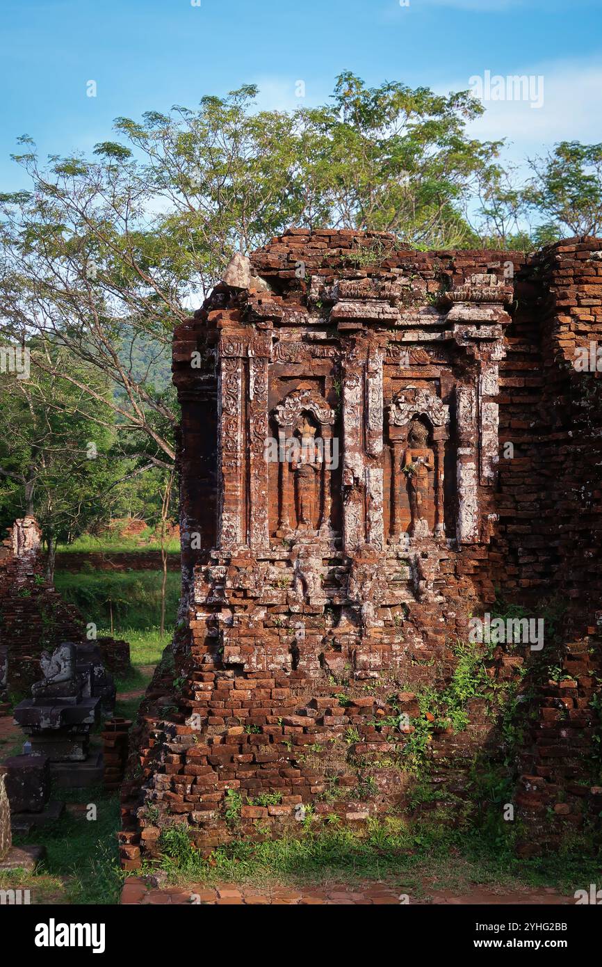 Ancient carved stone relief on weathered temple wall, partially ...