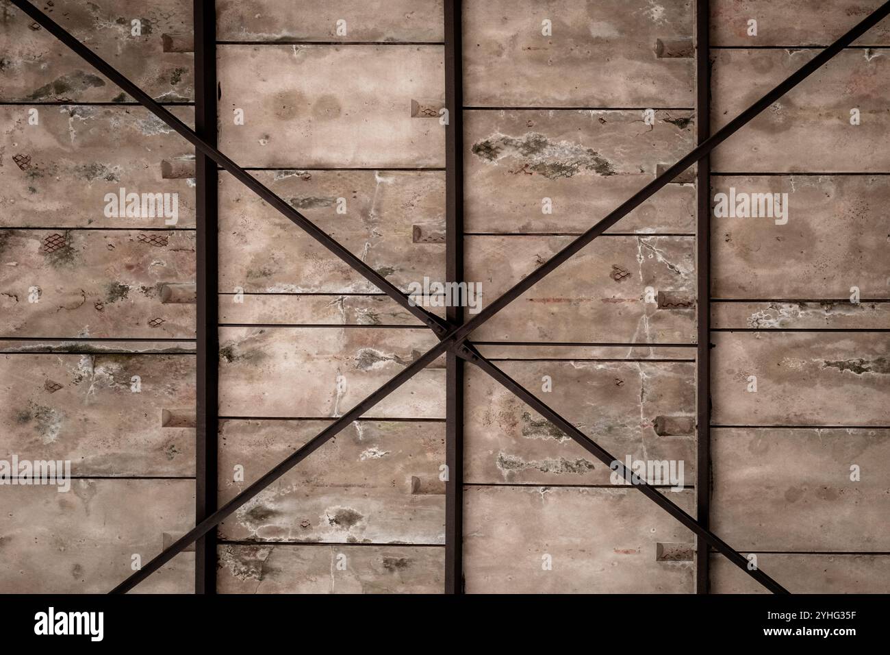 Worn cement ceiling tiles and rusting metal frame in old factory Stock ...