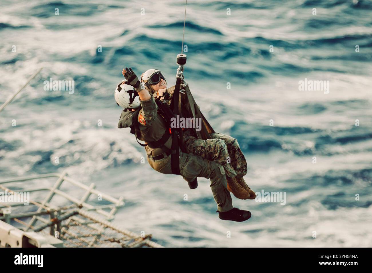 A U.S. Sailor assigned Helicopter Sea Combat Squadron (HSC) 23 hoists U ...