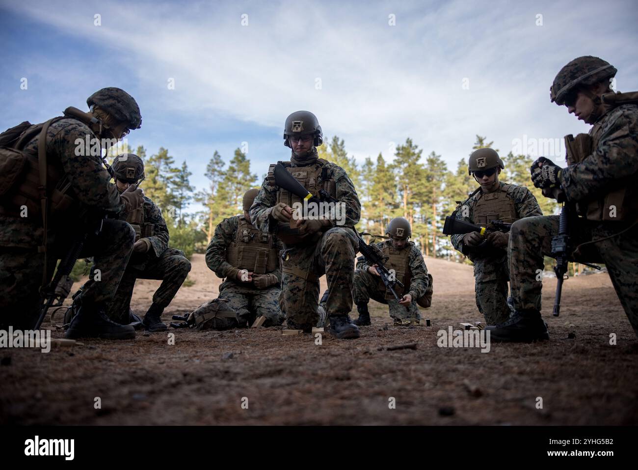 U.S. Marines load magazines during a live fire range in preparation for ...