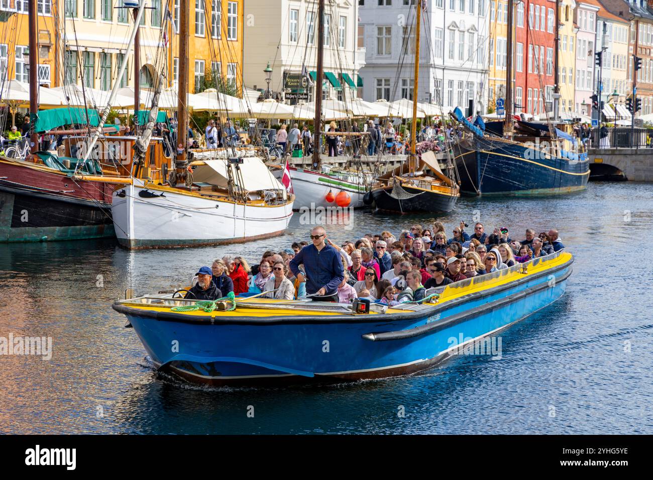 Copenhagen, people on a canal boat tour along the Nyhavn canal past the ...