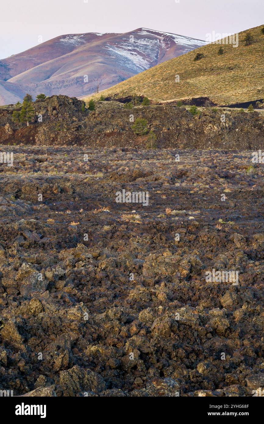 Earth's shadow rising behind high desert mountains beyond a lava field ...