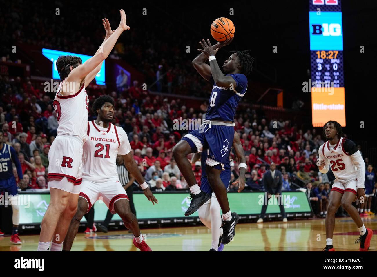 St. Peter's Bryce Eaton, center, goes up to shoot over Rutger's Zach ...
