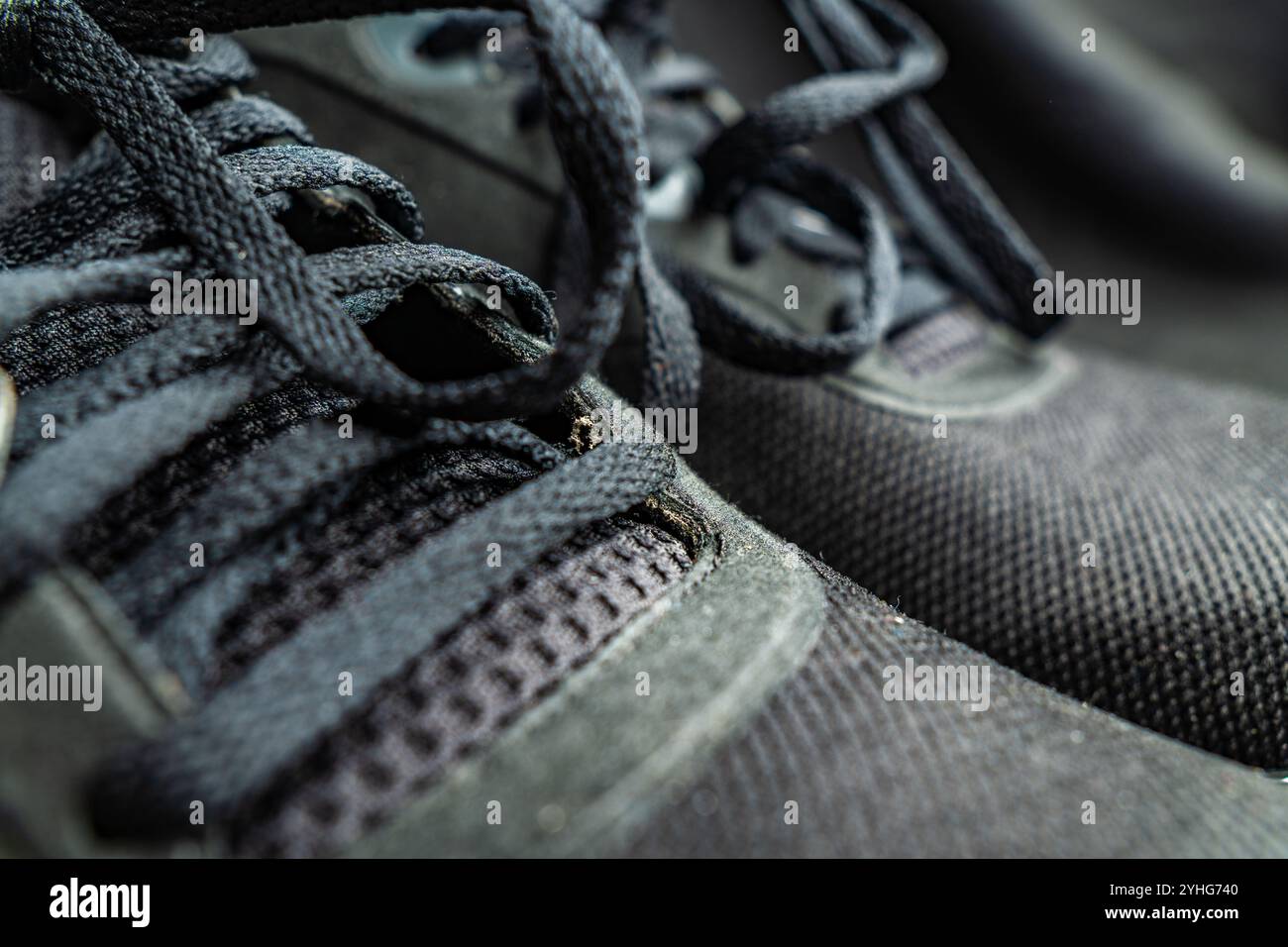 Close-up detail of black athletic shoes showcasing lace texture and ...