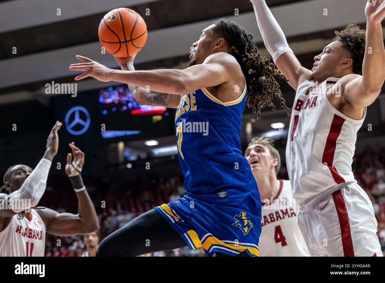 McNeese State guard Alyn Breed (7) works past Alabama guard Mark Sears ...