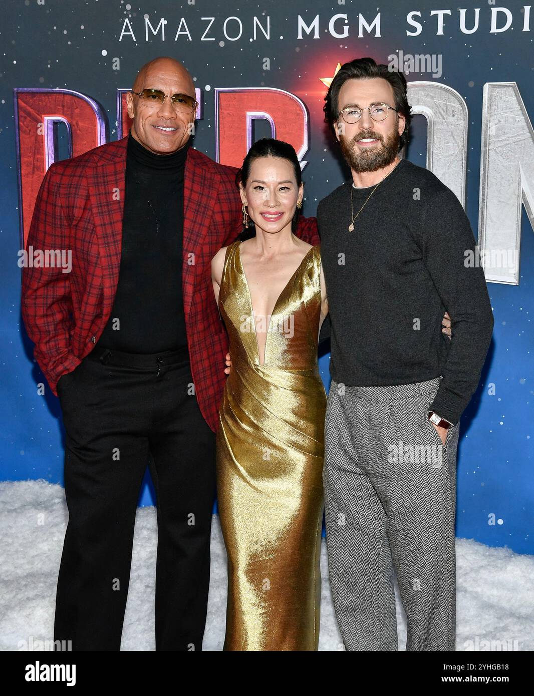 Dwayne Johnson, left, Lucy Liu and Chris Evans pose together at the ...