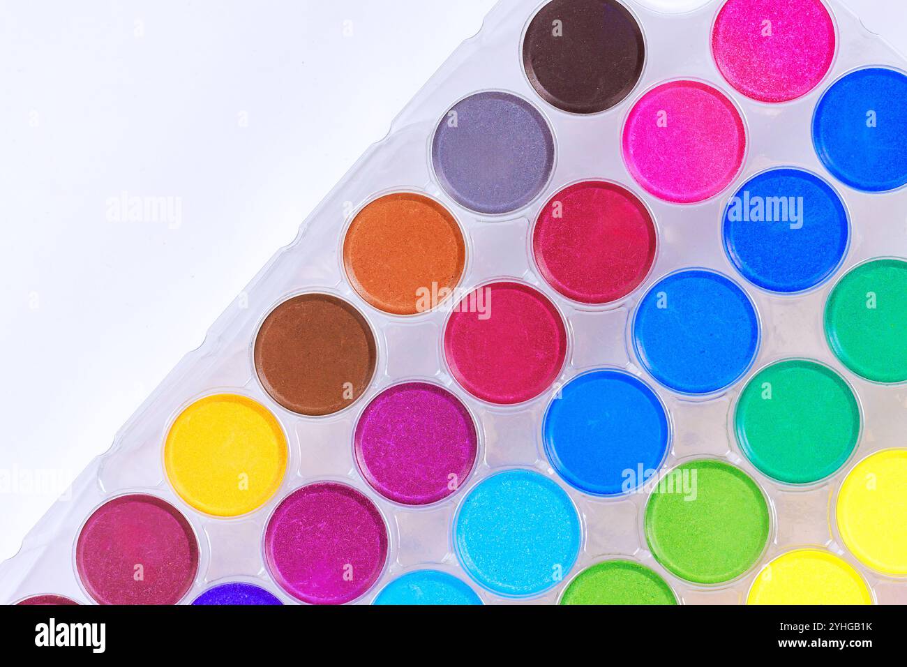 Essential tools for artists, watercolors arranged in rainbow of colors ...