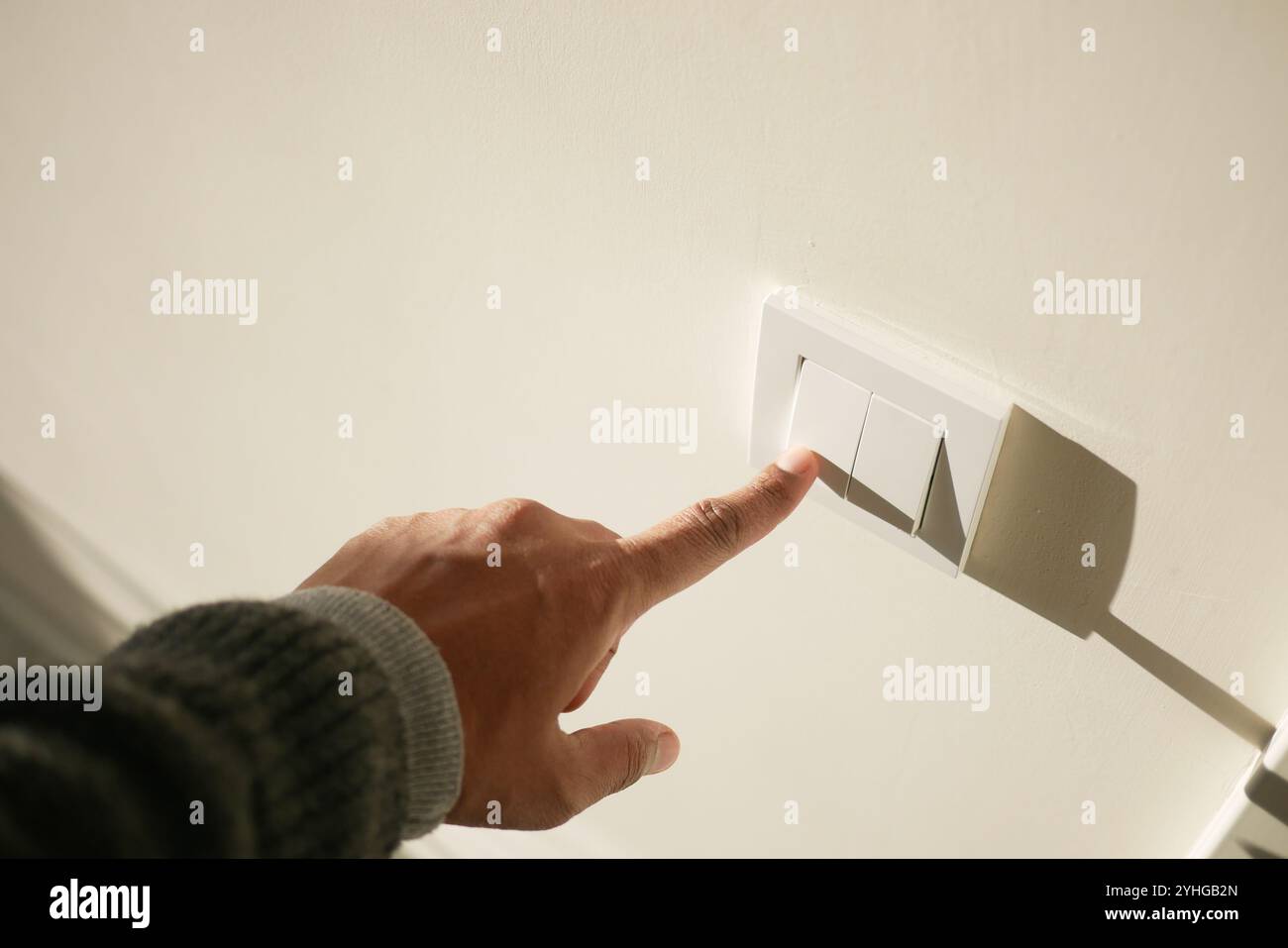 A finger turning on lighting switch Stock Photo - Alamy