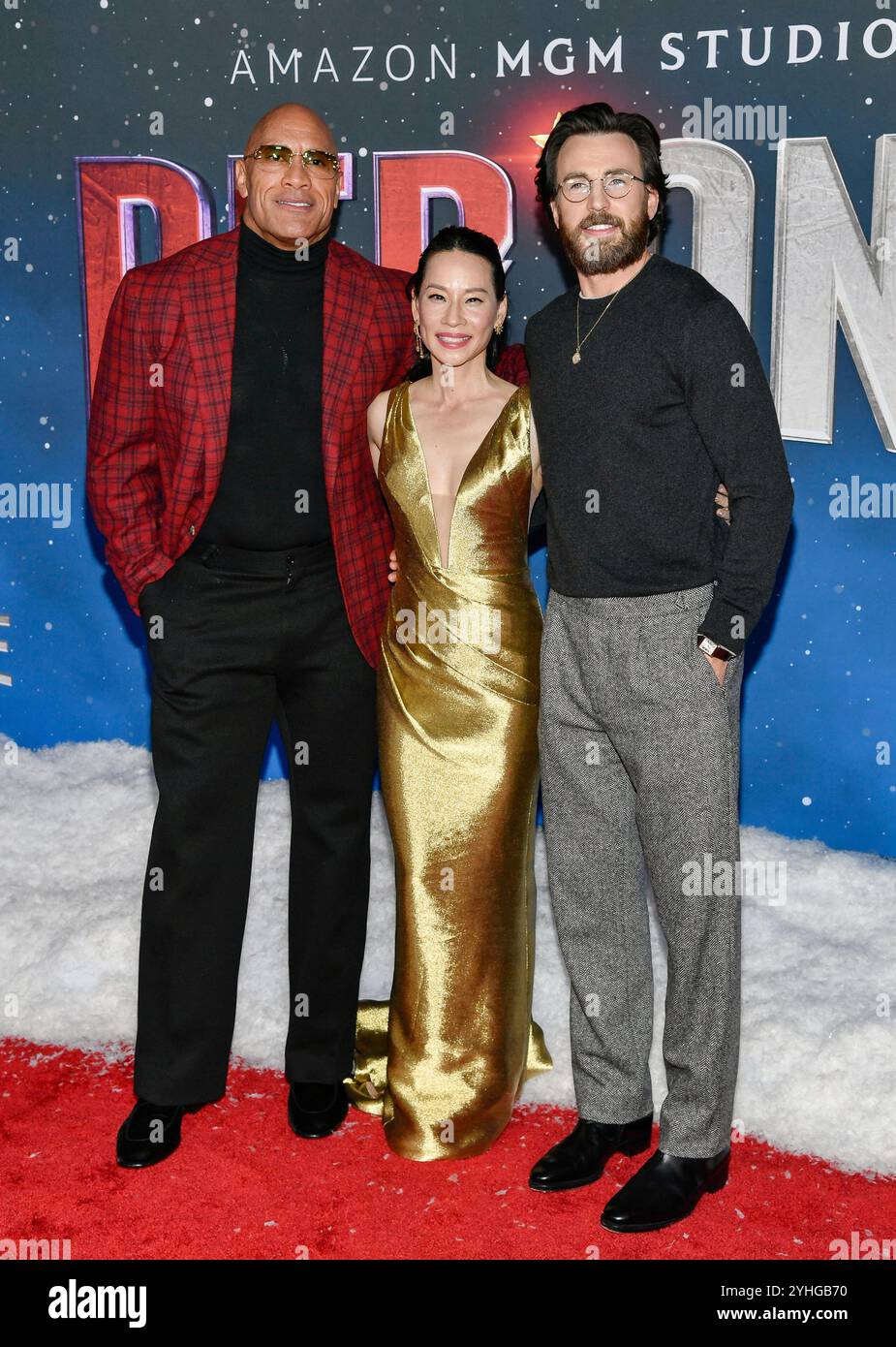Dwayne Johnson, left, Lucy Liu and Chris Evans pose together at the ...