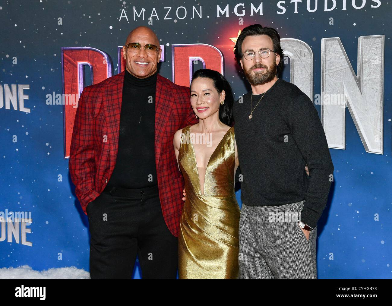 Dwayne Johnson, left, Lucy Liu and Chris Evans pose together at the ...