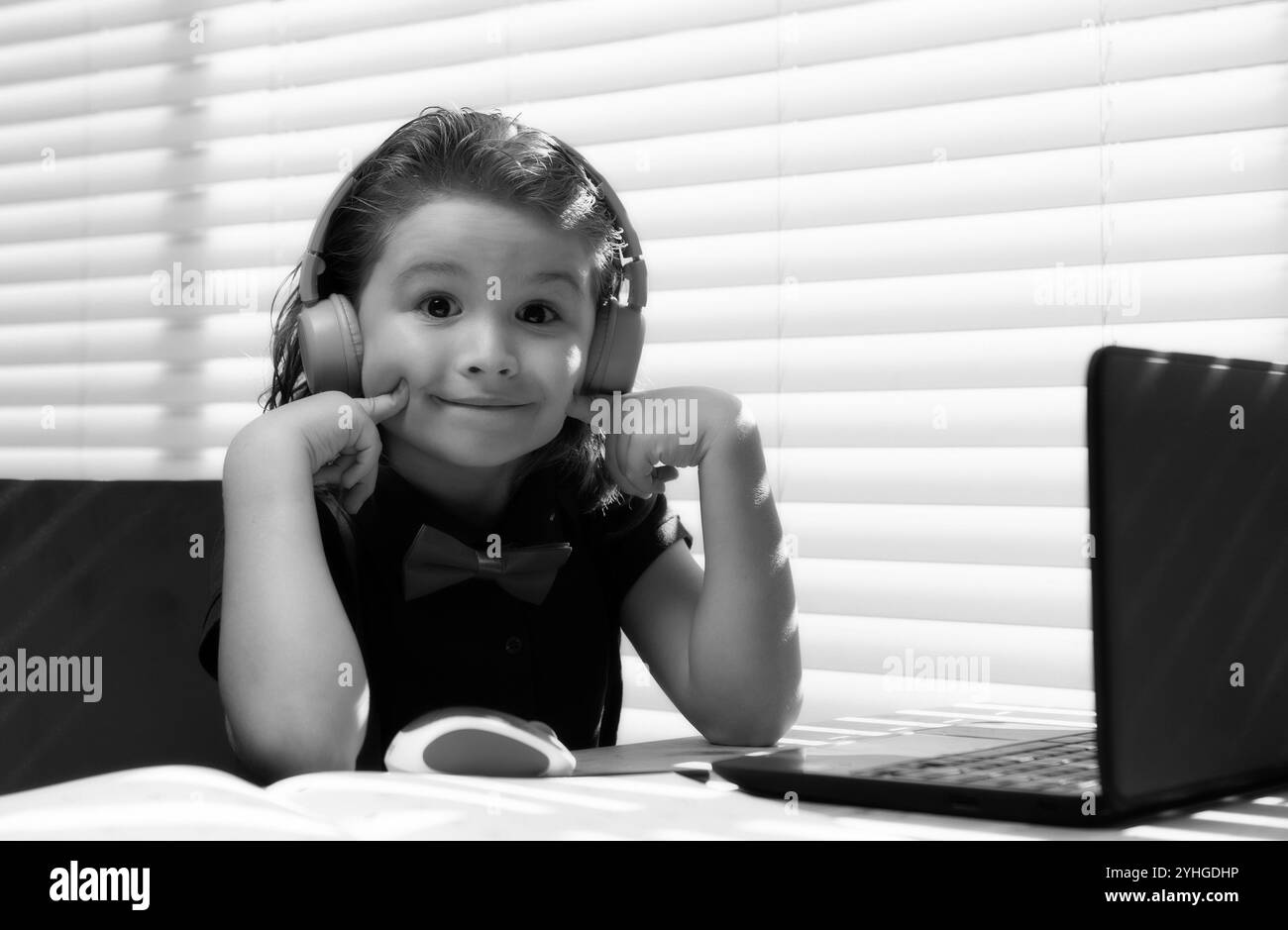 Child boy using a laptop and study online lesson. Pupil at school. Cute ...