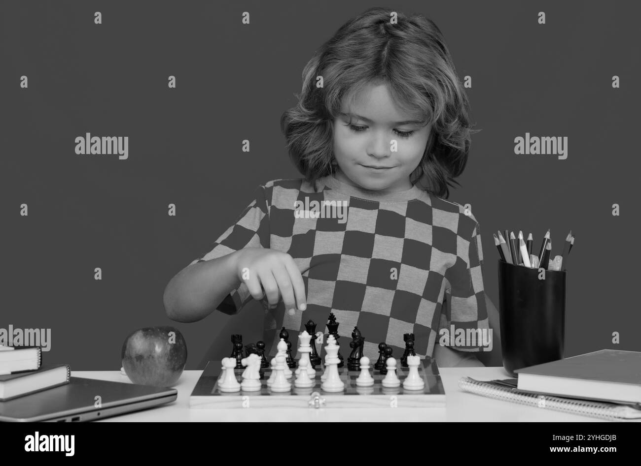 Child play chess on studio background. Little kid play chess. Thinking ...