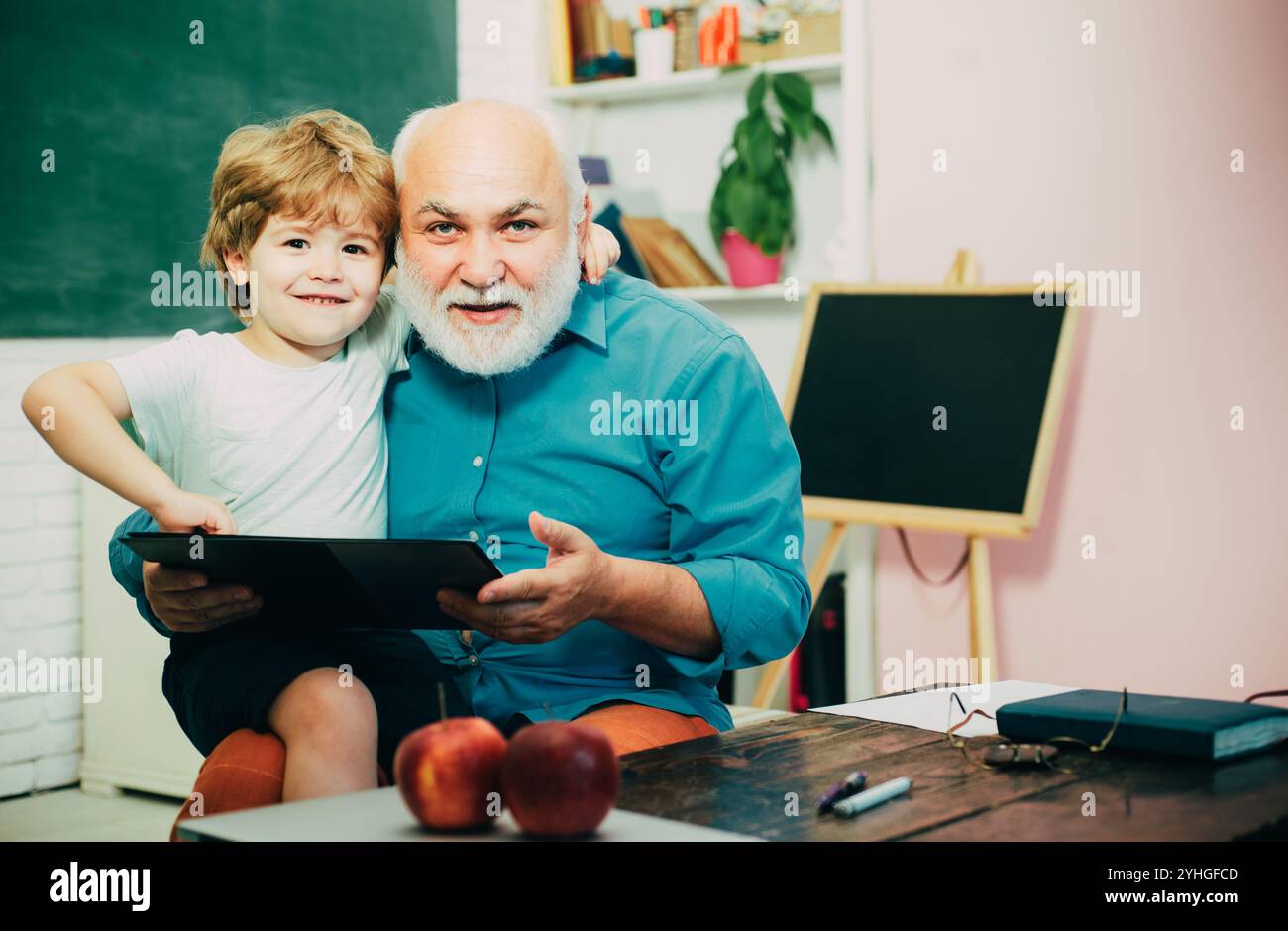 Cute little preschool kid boy with Grandfather in a classroom ...