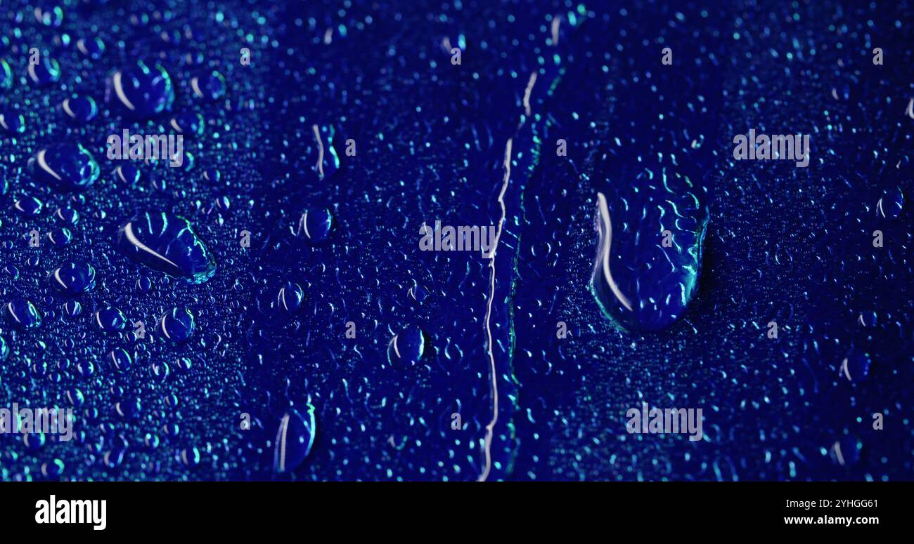 Wet surface. Blue droplet. Fresh raindrops spill on glossy smooth area ...
