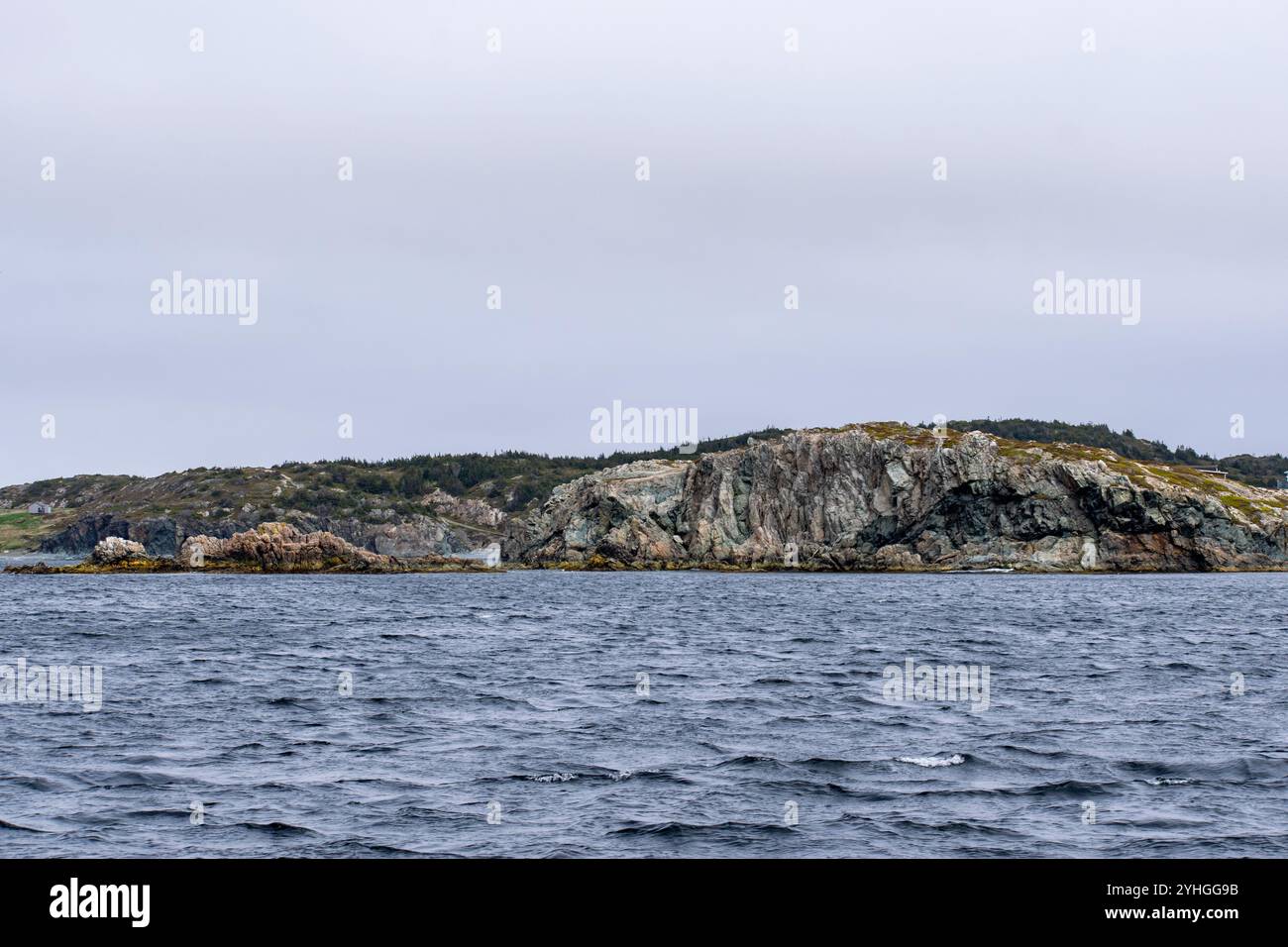 Majestic rocky cliffs rise sharply from the sea, capturing the untamed ...
