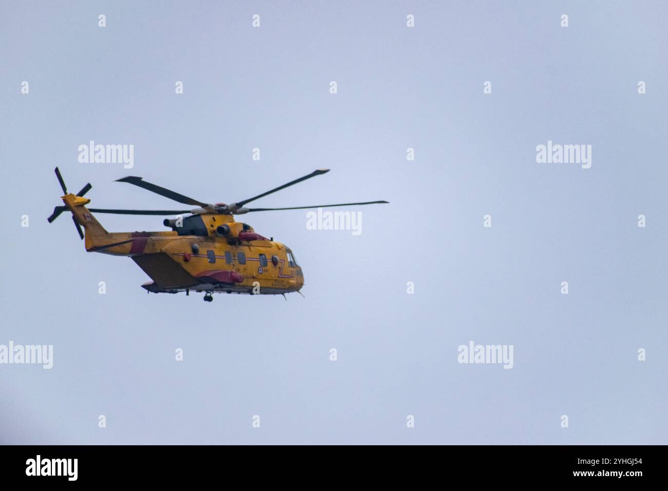 A Canadian rescue helicopter hovers in the sky, poised for action as it ...