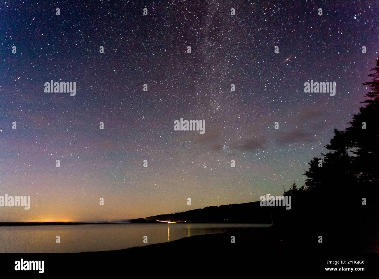 The night sky and Milky Way Galaxy emerging over the calm waters of Big ...