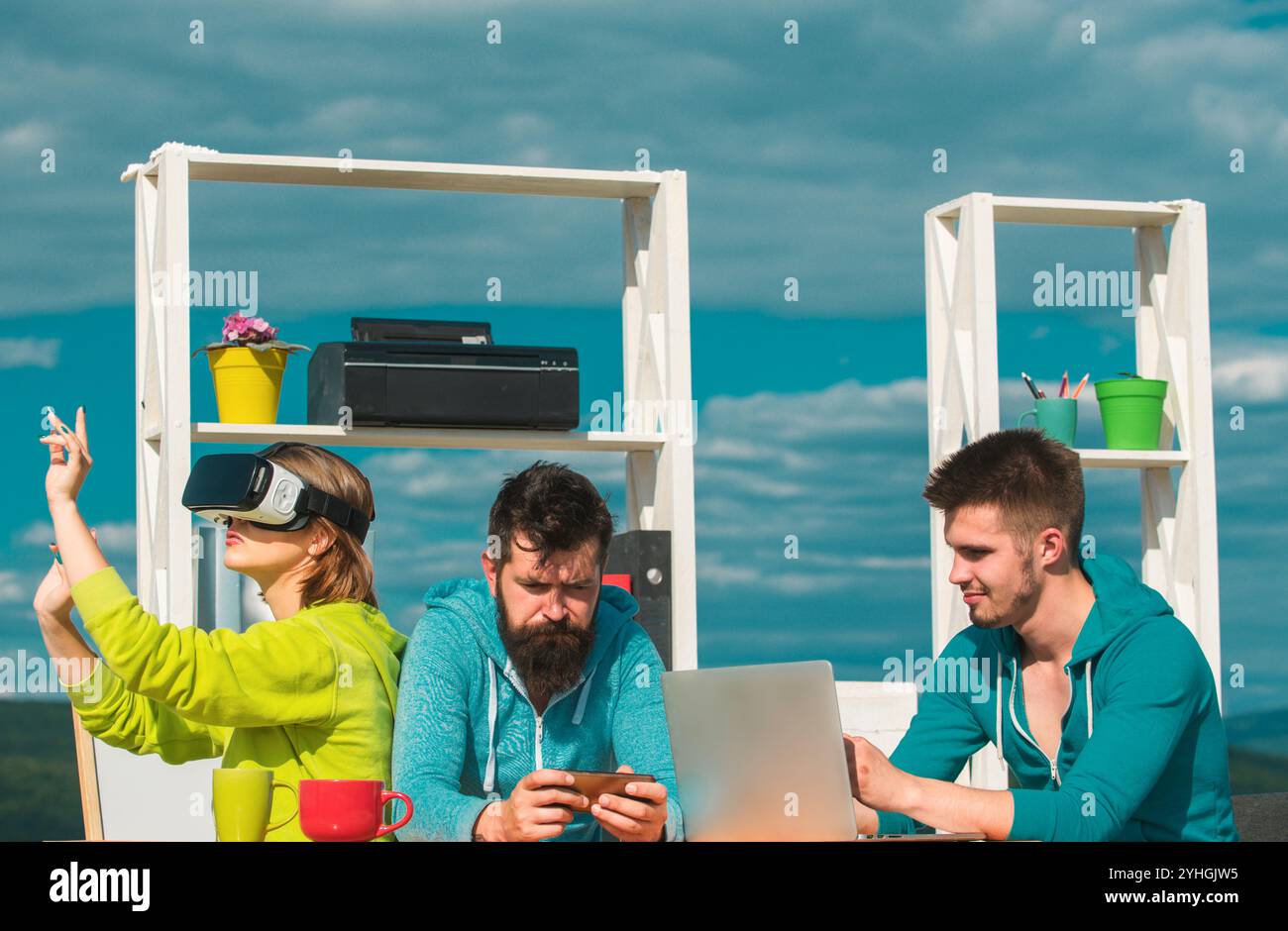 Team of three professional male and female designers wearing vr ...