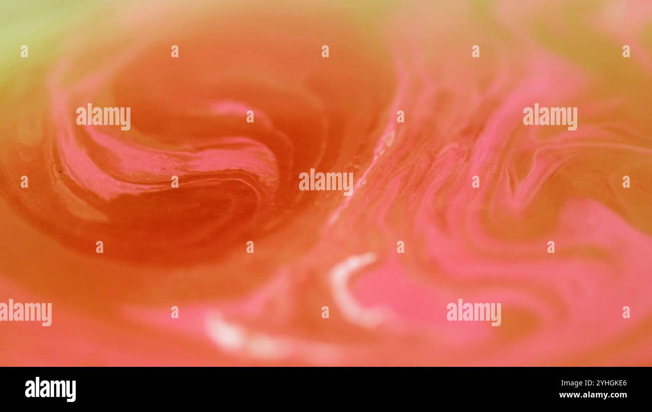 Sparkling fluid. Liquid ink mix. Blur orange pink color shiny dust ...