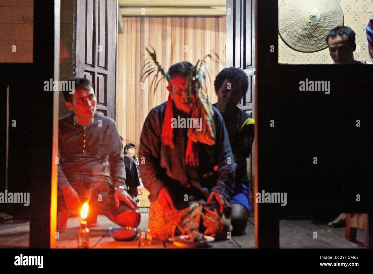 A witch doctor conducting a ritual on the porch of Dayak Iban's ...