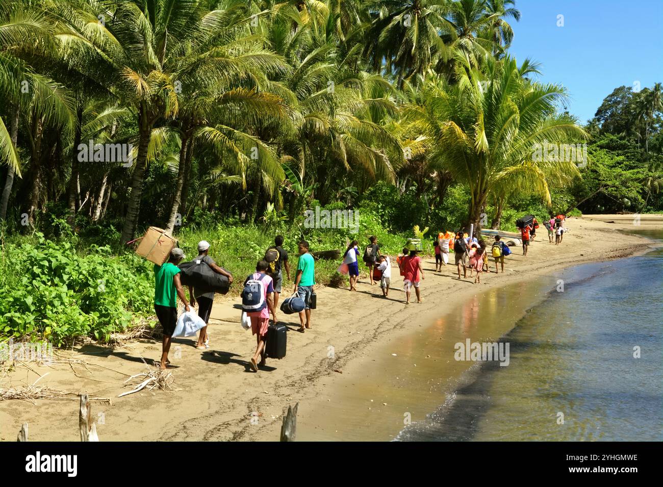 Local people carrying luggages belong to tourists, walking along the ...