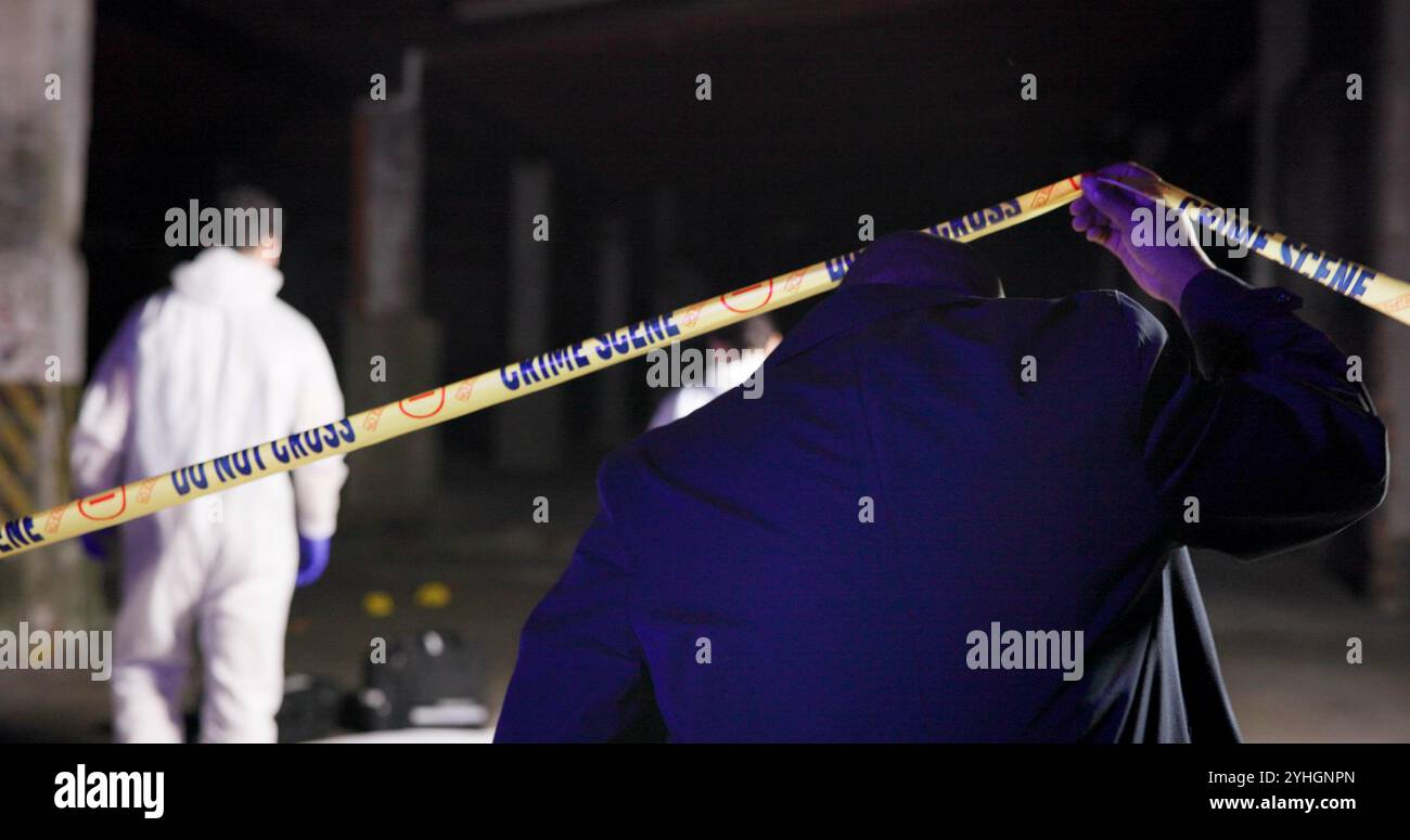 Detective, yellow tape and back at crime scene with forensic team ...
