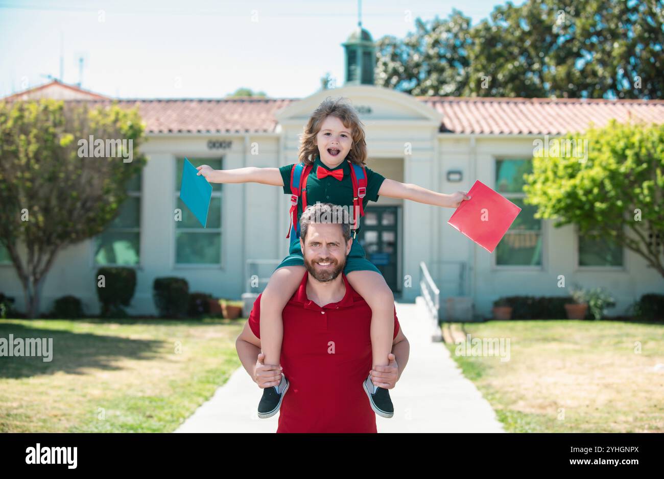 School boy going to school with father. First day of fall. Dad and son ...