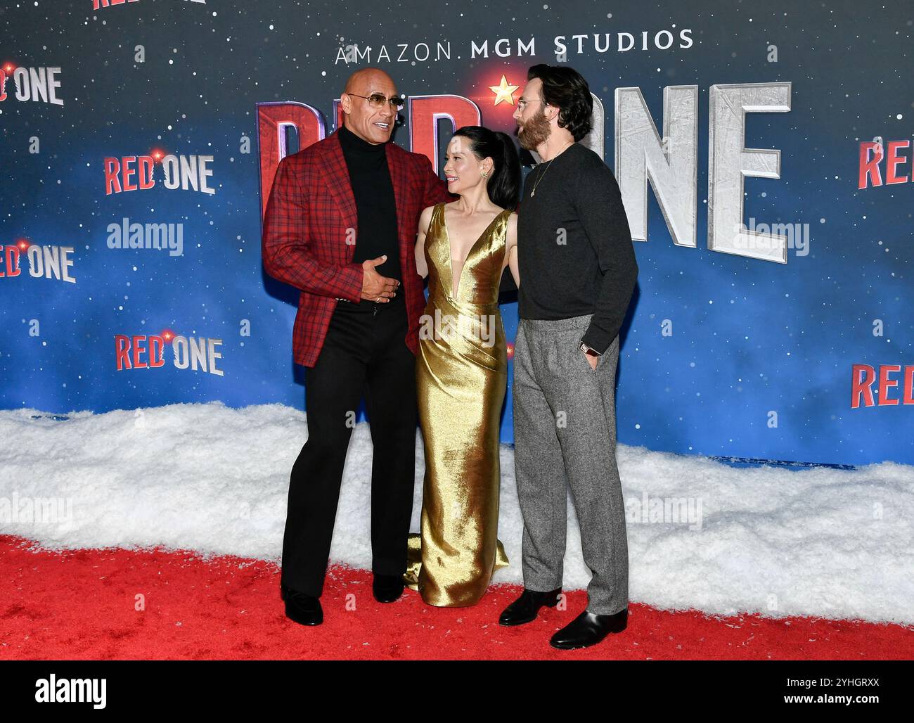 Dwayne Johnson, left, Lucy Liu and Chris Evans pose together at the ...