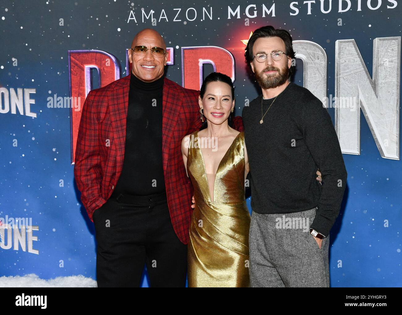 Dwayne Johnson, left, Lucy Liu and Chris Evans pose together at the ...
