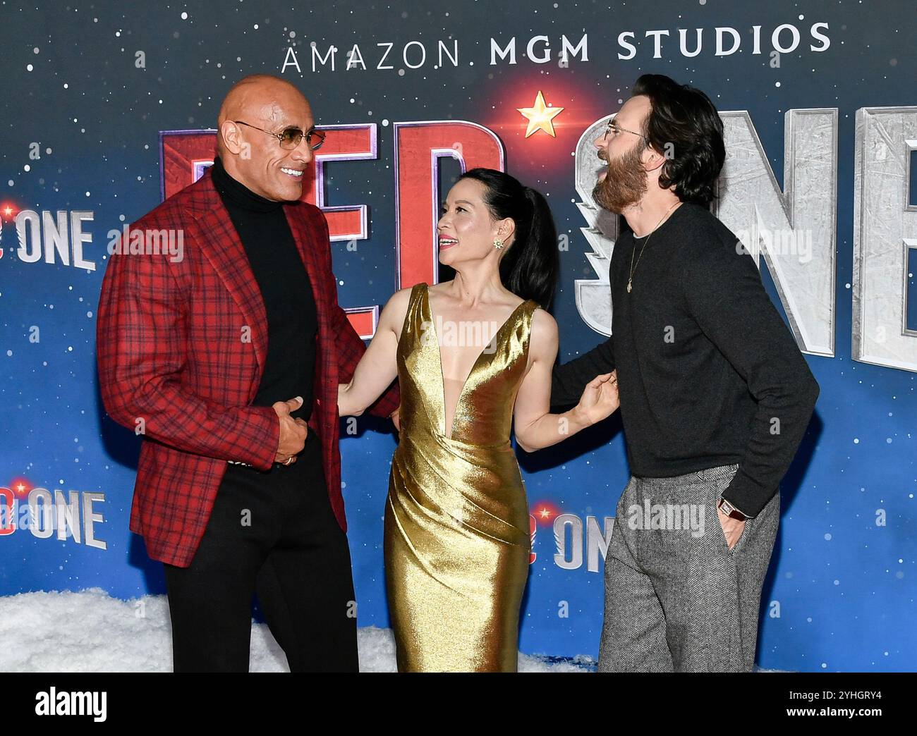 Dwayne Johnson, left, Lucy Liu and Chris Evans pose together at the ...