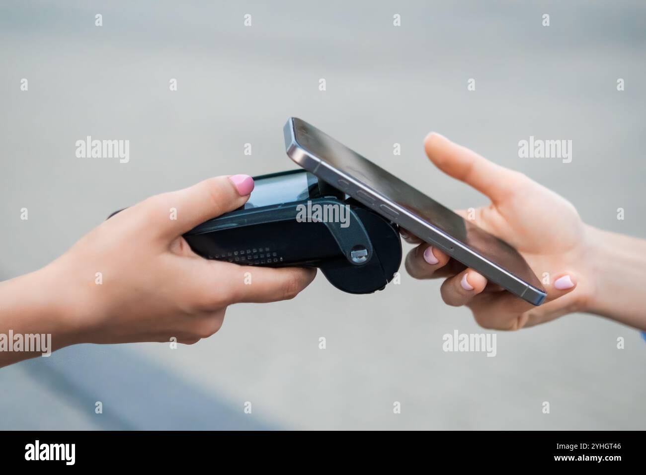 Contactless payment processing at a retail store using a terminal and smartphone Stock Photo - Alamy