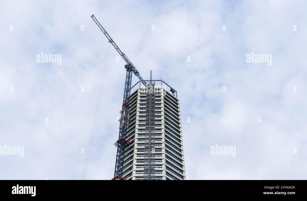 Tall crane being used in the construction of a modern apartment ...