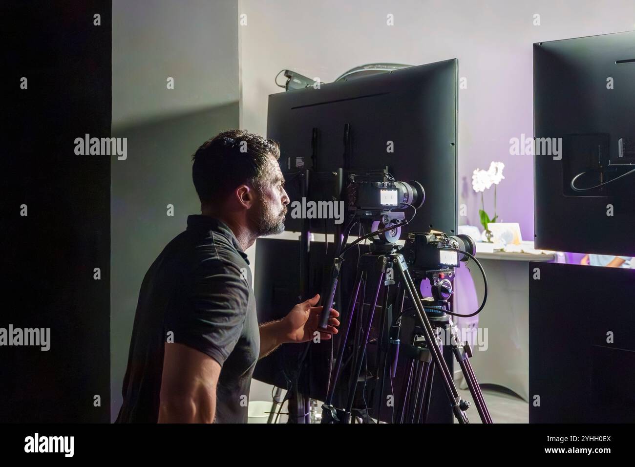 Mature Male Camera Operator Setting Up Cameras During a Live Broadcast ...