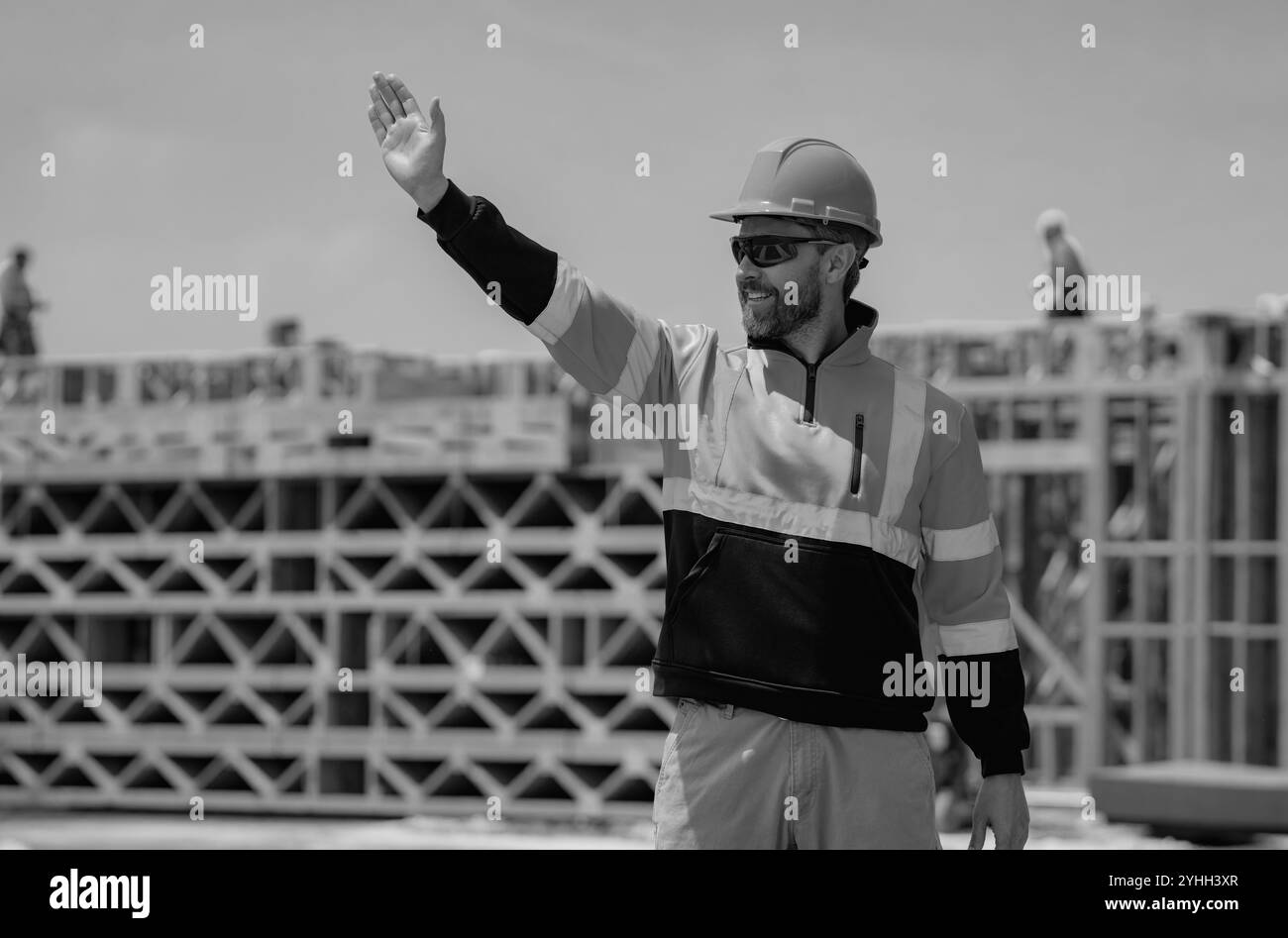Builder with hardhat helmet on construction site. American wood frame ...