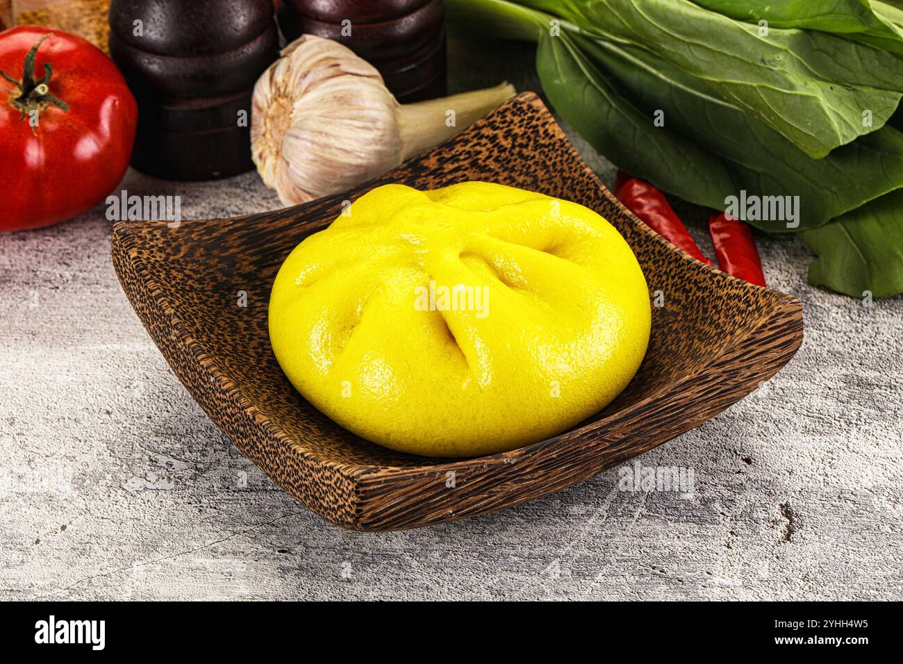 Asian stuffed steamed yellow Bun Bao Stock Photo - Alamy