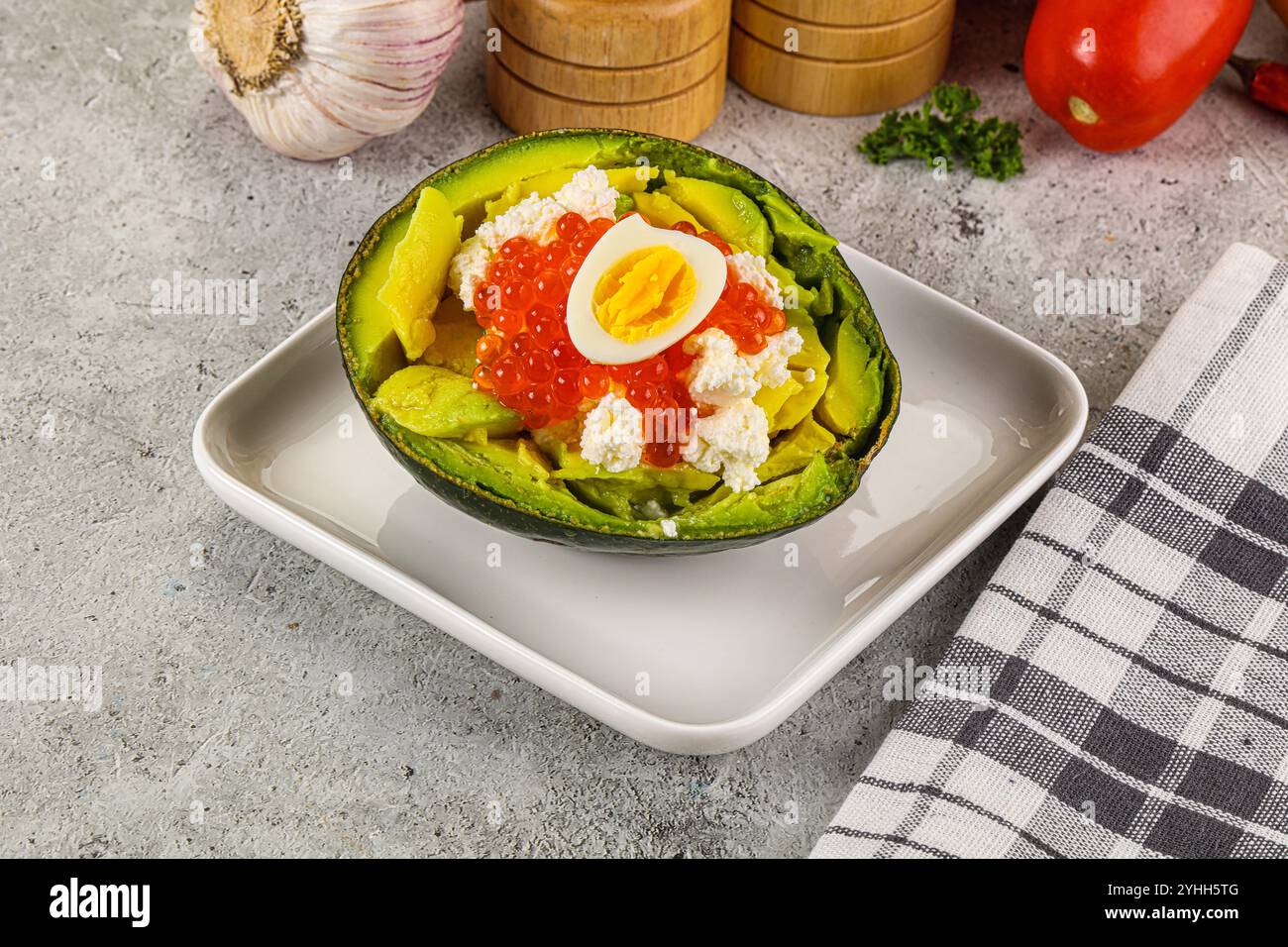 Avocado with red caviar and quil egg and soft cheese Stock Photo - Alamy