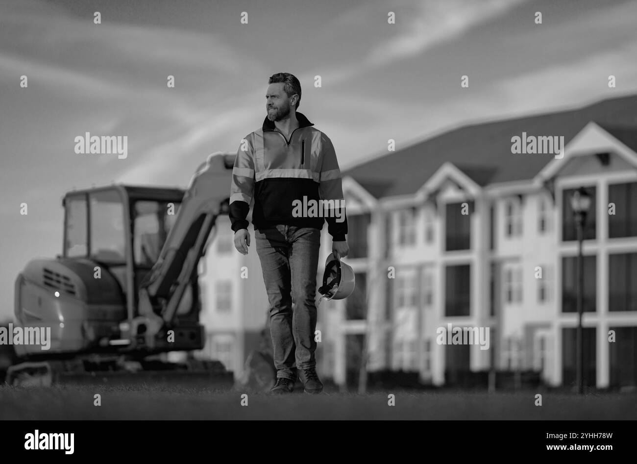 Man at construction site. Worker constructor in hardhat. Construction ...