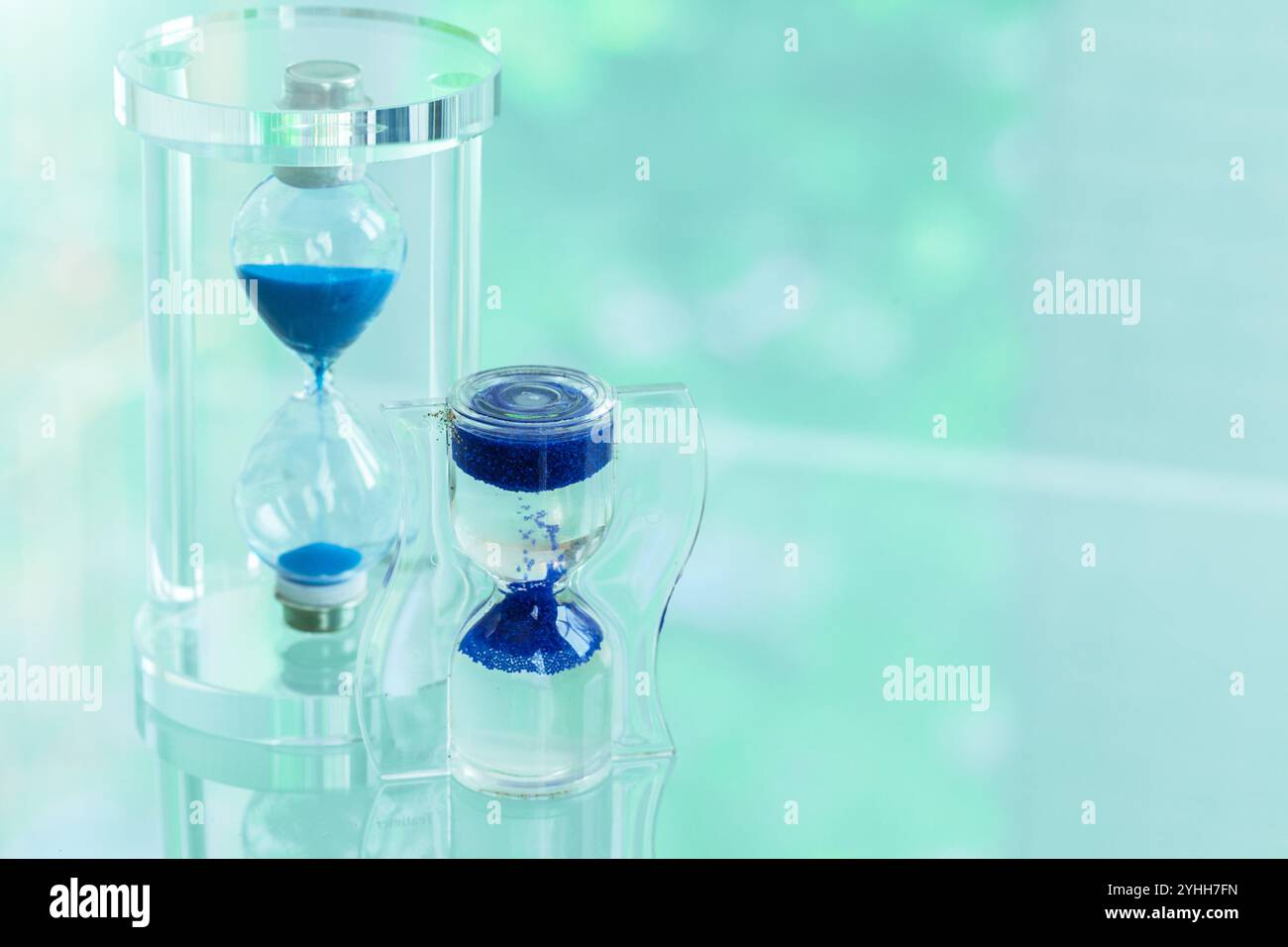 Time passing. Blue hourglass Stock Photo - Alamy