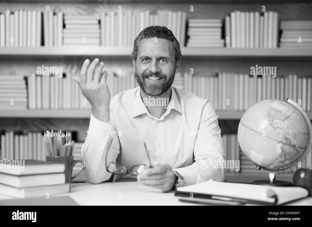 Portrait of teacher in library classroom. Handsome teacher in ...