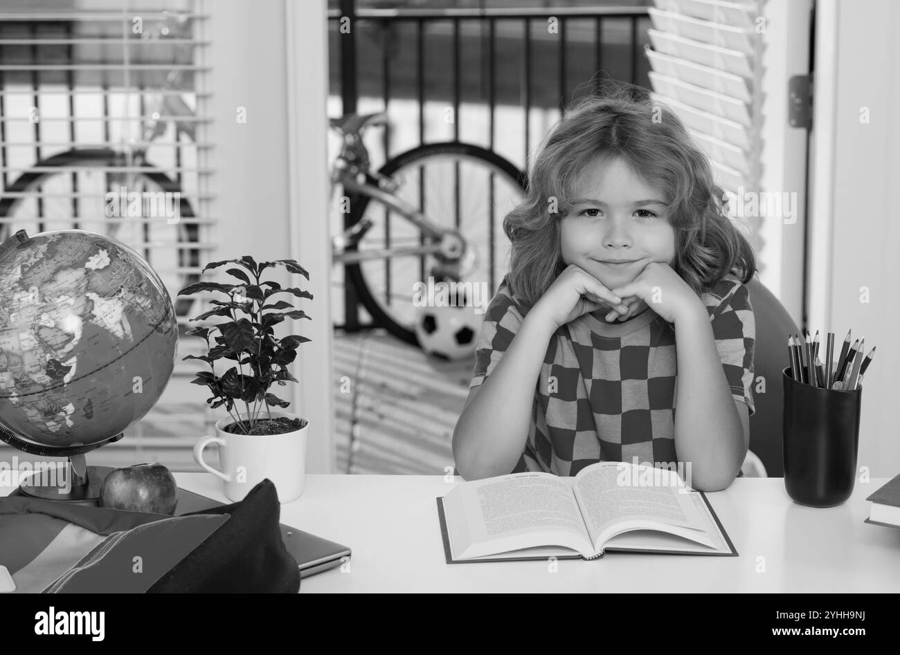 Child reading book. School child studying in classroom at elementary ...