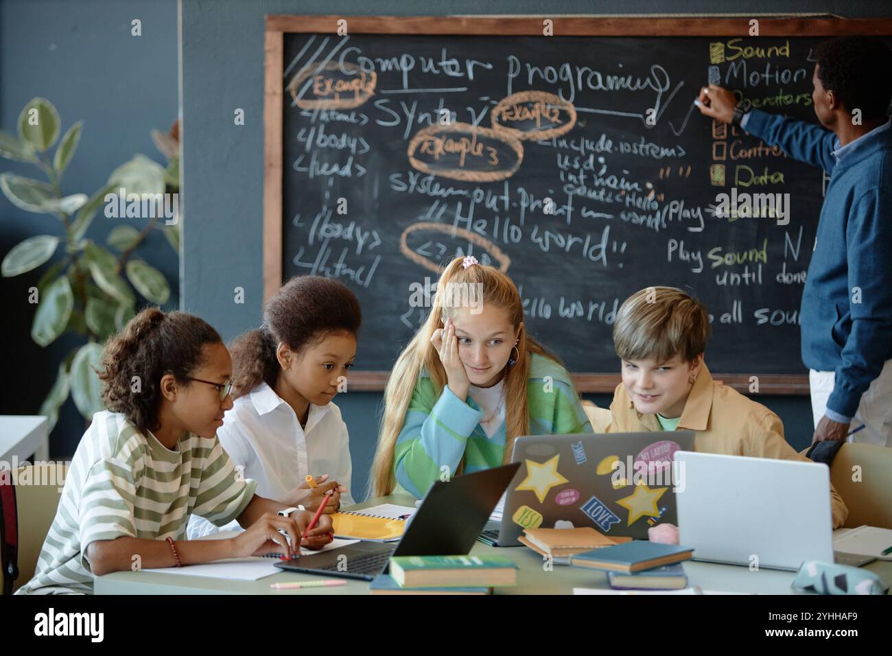 Front view at group of puzzled children working together in school ...