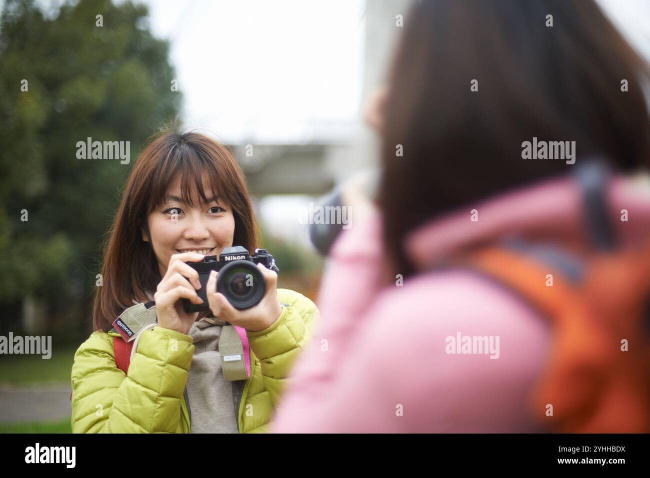 Women taking photos of each other Stock Photo - Alamy