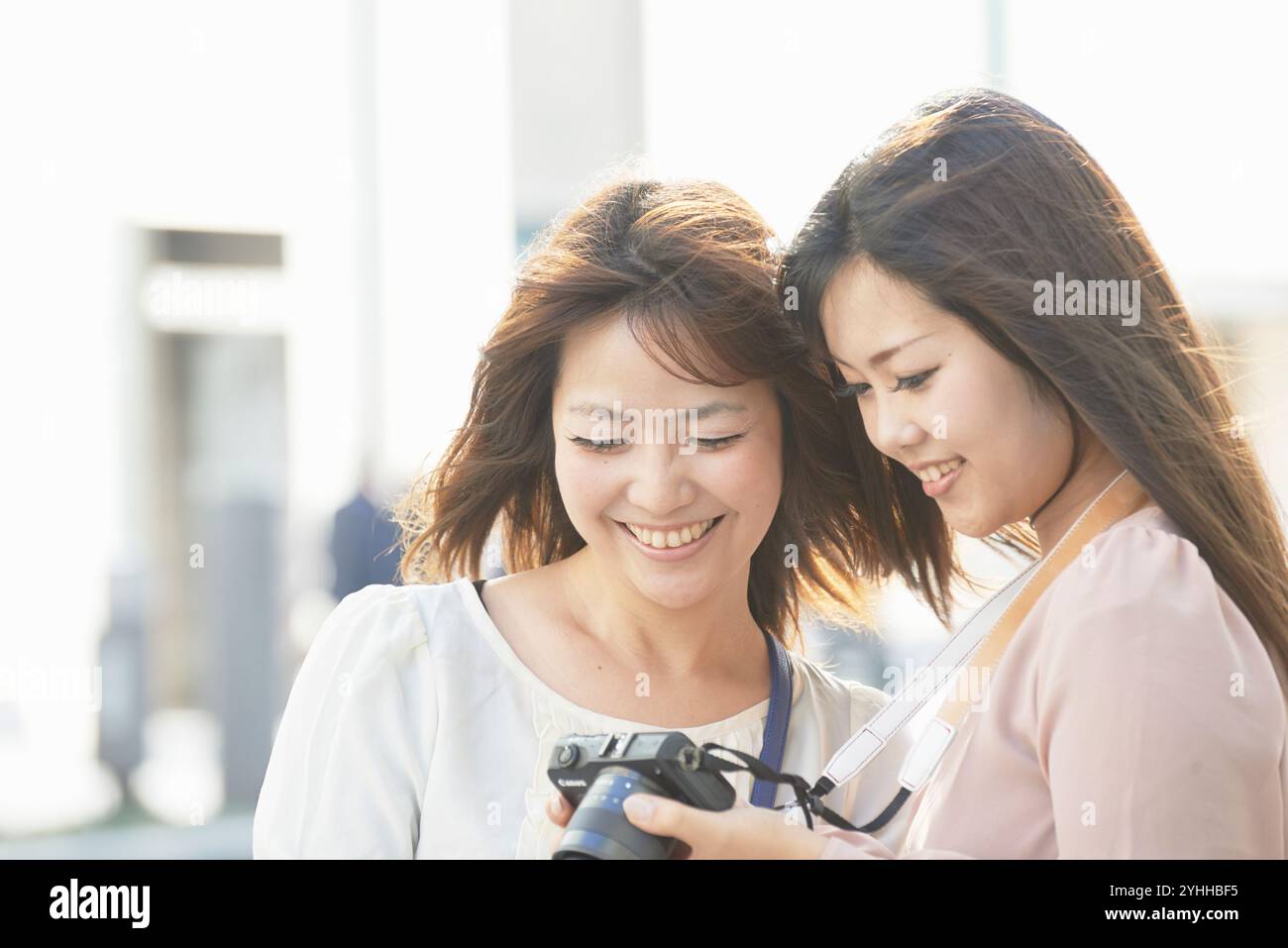 Women looking at guidebook Stock Photo - Alamy