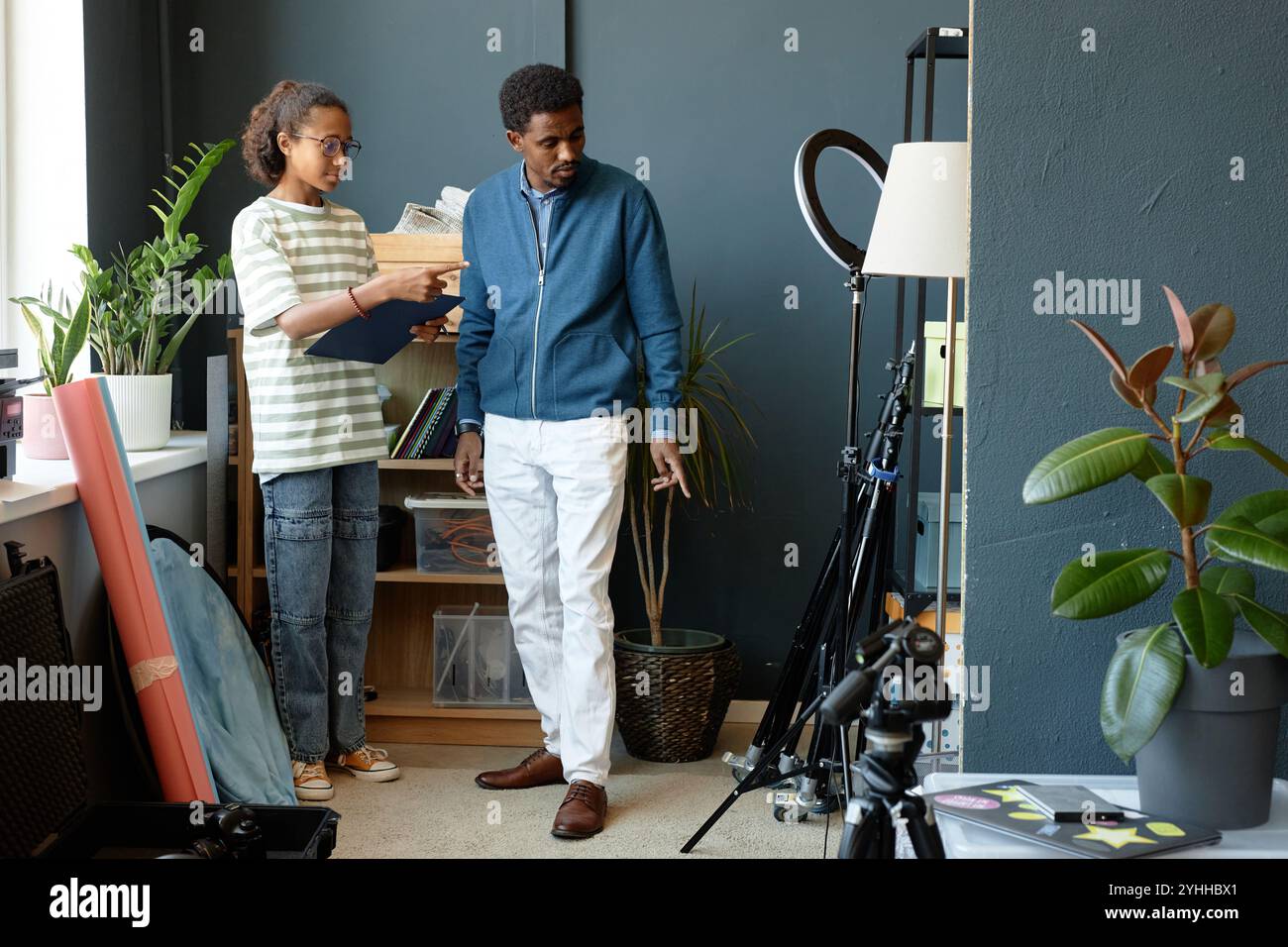 Full length shot of African American teenage boy setting up backstage ...