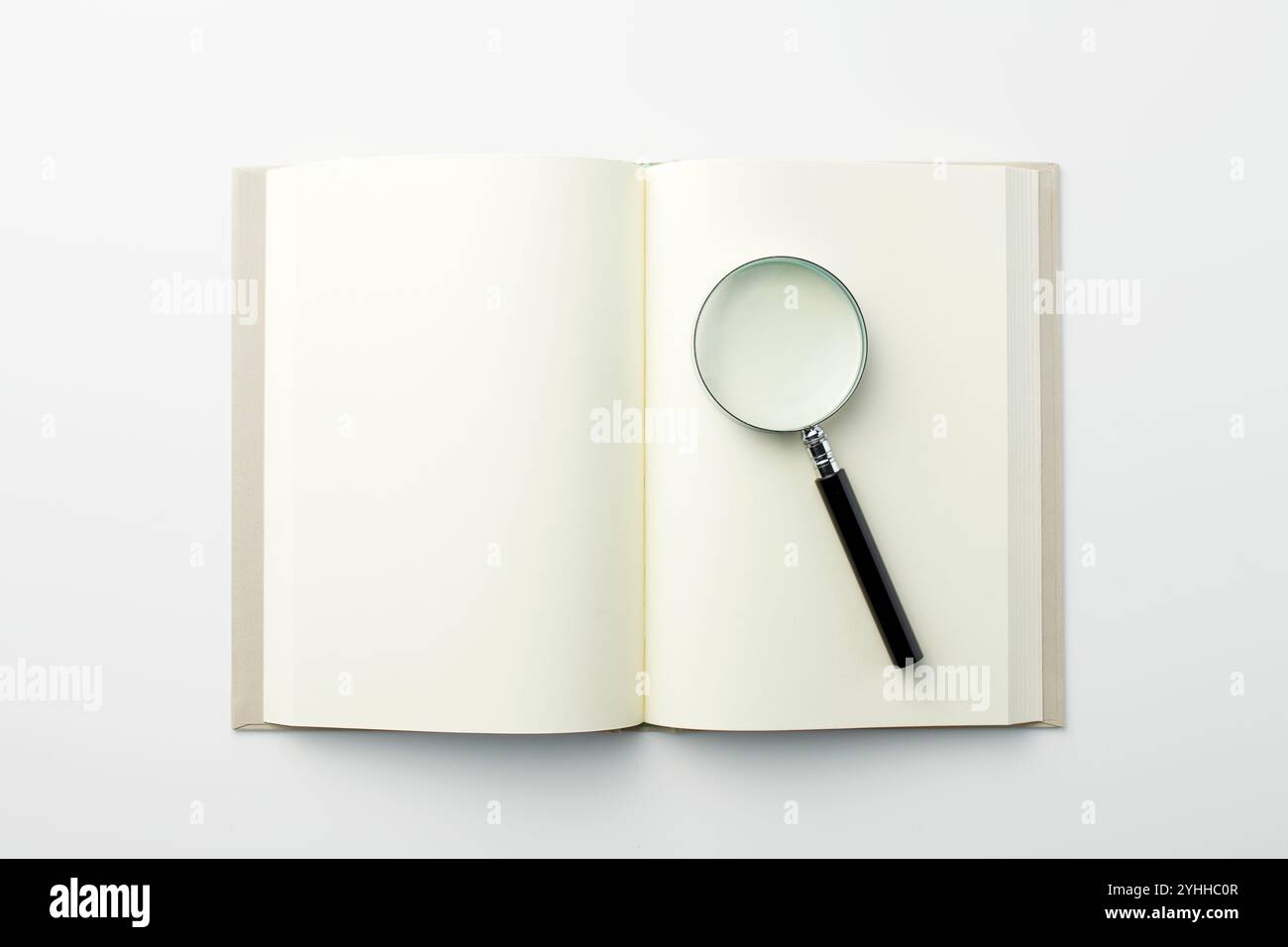 Book and magnifying glass Stock Photo - Alamy