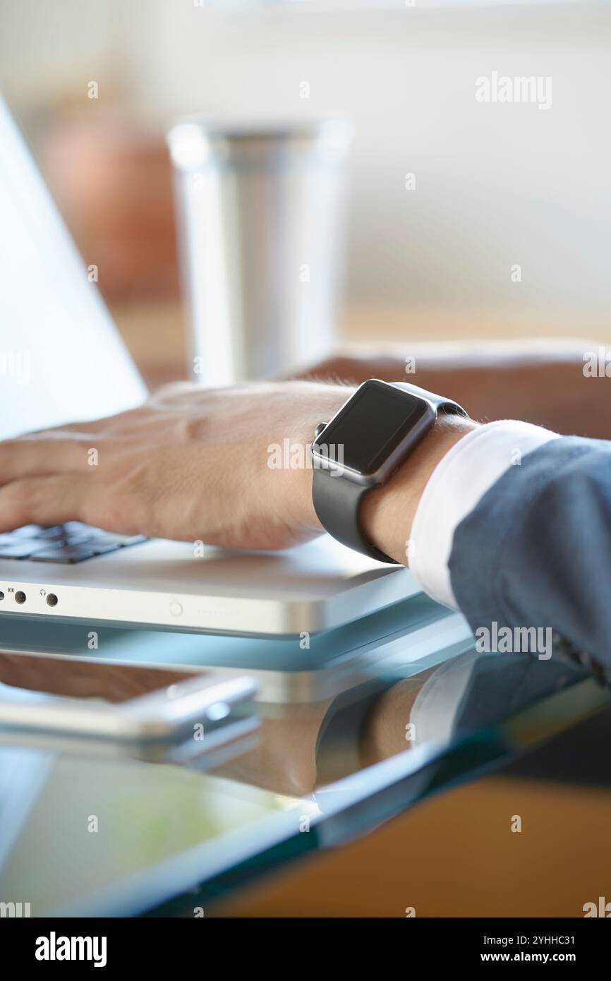Man working wearing a smartwatch Stock Photo - Alamy